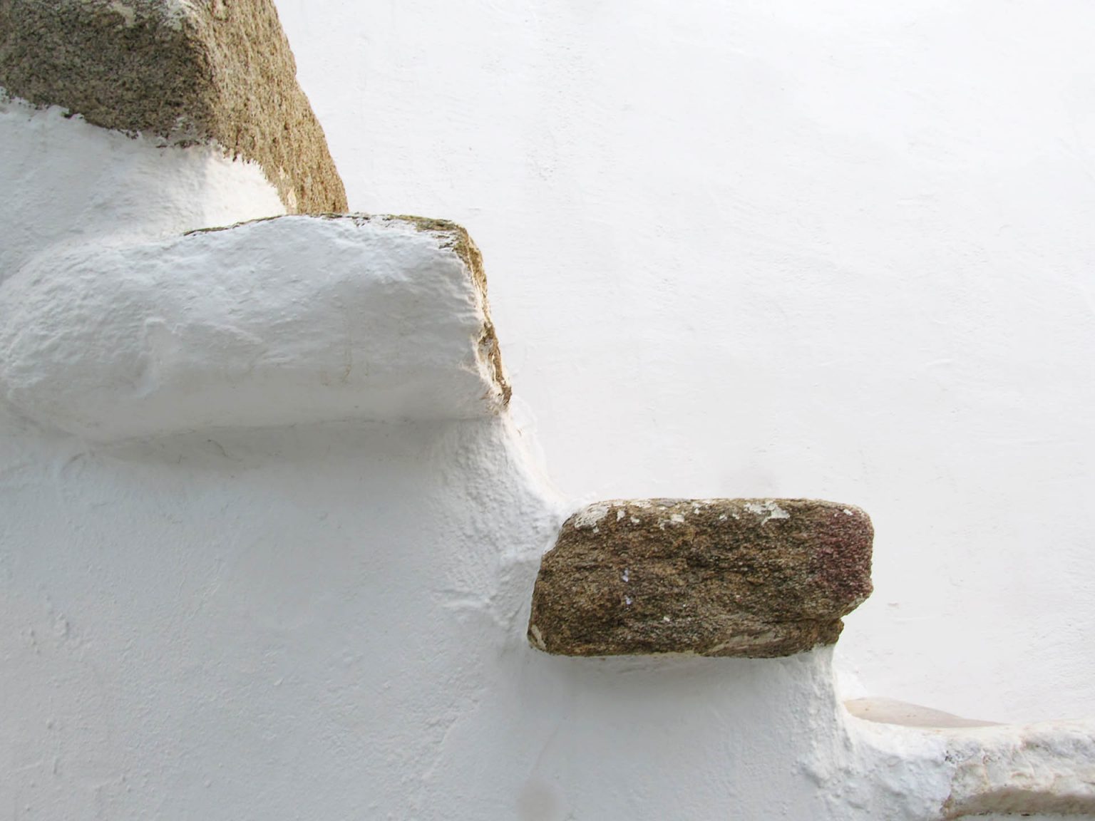 stone steps detail of a limewashed building – TEORA Mykonos
